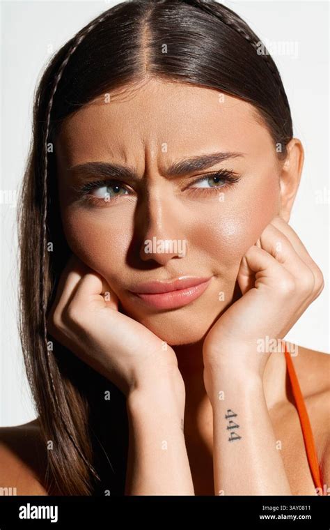 Young Woman With A Sun Tan Reflects On Summertime While Playfully