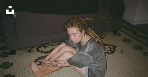 A Woman Sitting On The Floor With Her Legs Crossed Photo Free Valencia Image On Unsplash