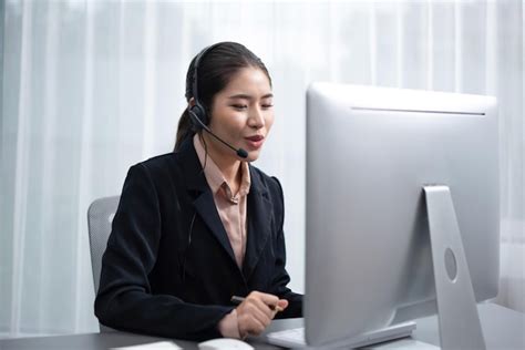 Premium Photo Enthusiastic Asian Call Center With Headset And Microphone Working On Her Laptop