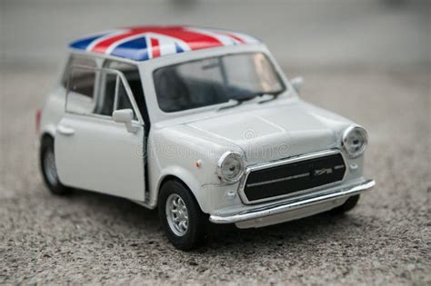 Closeup Of Old White Mini Cooper With British Flag On Roof On Stoned Background Editorial Image