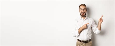 Premium Photo Excited Handsome Man Pointing Fingers At Upper Right