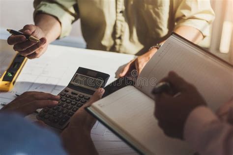Group Of Architects Discussing And Useing Calculator About Calculate The Cost With For Working