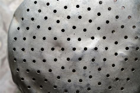 Premium Photo Crumpled Old Aluminum Colander With Holes Closeup