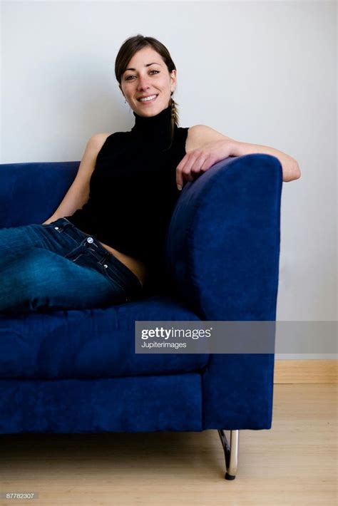 Woman Posing On Couch By Jupiterimages 87782414
