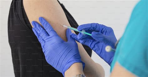 Ppe 슈트와 수술용 마스크를 착용하고 검역실에서 감염된 환자와 함께 백신을 사용하는 의사 Covid 19 코로나바이러스 발생