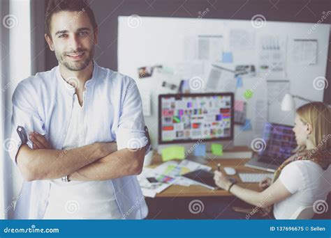 Portrait Of Young Designer In Front Of Laptop And Computer While