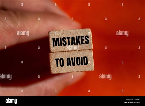Mistakes To Avoid Message Written On Wooden Blocks With Orange