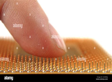 Old Microprocessor And Human Hand Isolated On The White Background