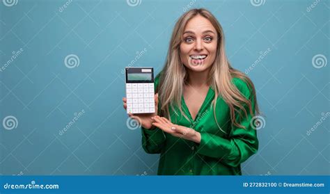European Pleasantly Perplexed Stylish Blonde Girl With A Calculator On