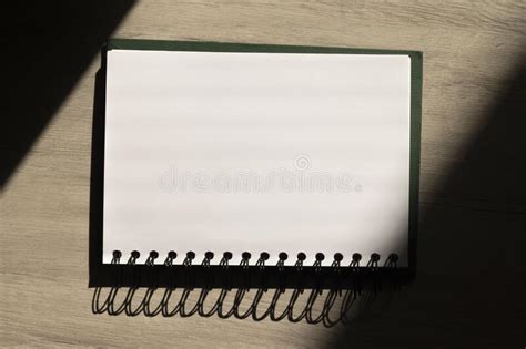 Unfolded Notebook With Sheets Lying On The Floor In The Sun Stock Image