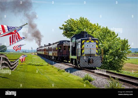 View Of Thomas The Train Pulling Passenger Cars While Passing American