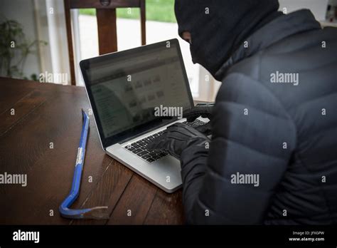 Thief Hacker Working On Laptop And Stealing Data Stock Photo Alamy