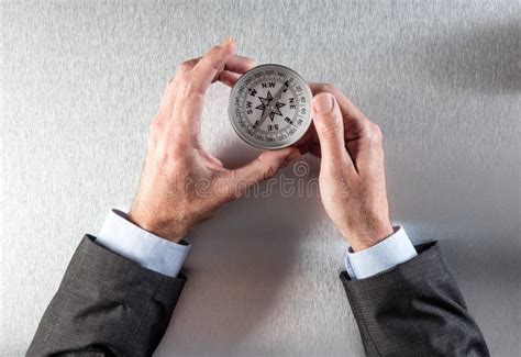 Businessman Hands Searching His Corporate Way Forward With A Compass