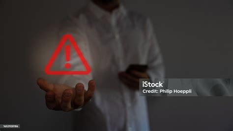 Hacking Concept Attention Warning Attacker Alert Sign With Exclamation Mark On Dark Red