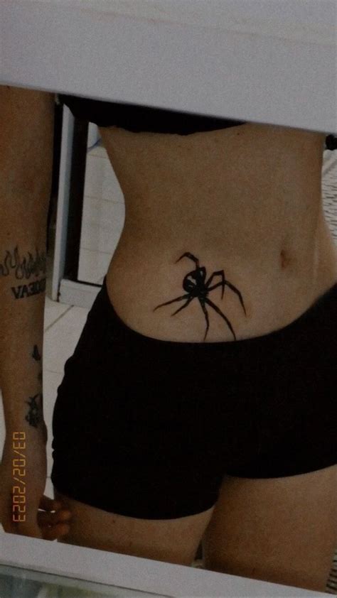 A Woman With A Spider Tattoo On Her Stomach