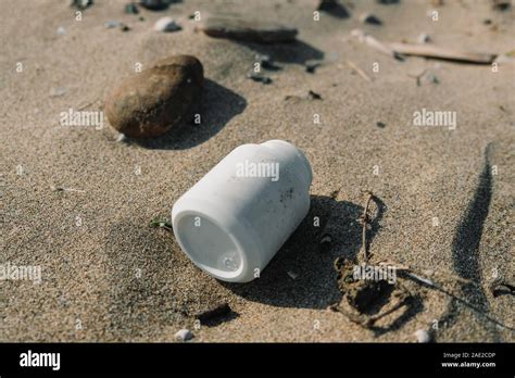 Plastic Container Pollution On Sea Coast Over Blur Backgroundplanet