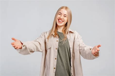 Portrait Of Attractive Female Model Stretching Out Arms At Camera For