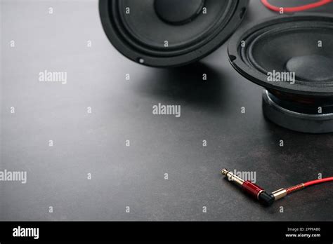 Close Up Red Auxauxiliary Cable With Male Jack With Speaker In The