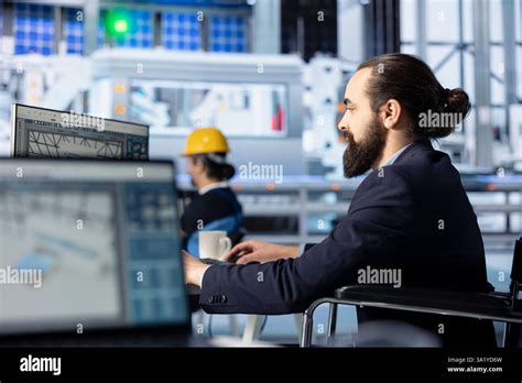 Photovoltaics Factory Engineer Looking At Pc Screen Adjusting System