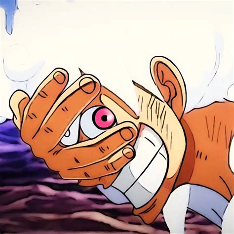 an orange and white cat with its mouth open holding something in it s