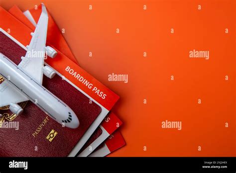 Top View Image Of Passport With Boarding Passes And A Toy Airplane On A