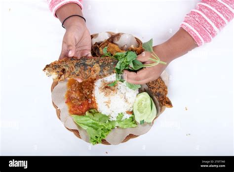 Hand Holding Fried Catfish With Rice Spicy Sauce And Vegetable Stock
