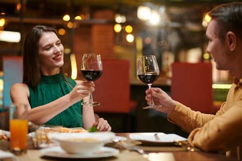Premium Photo Couple Toasting With Wine Glasses