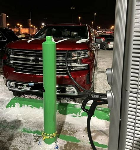 Cheeky Chevy Silverado Pretending To Be Charging At Ev Station With Cable Doesnt Fool Anyone