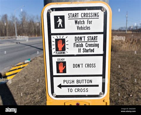The Image Shows A Pedestrian Instruction Sign Explaining When It Is