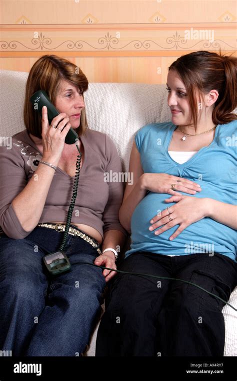 Young Heavily Pregnant Woman With Older Womanrelativemidwife Stock