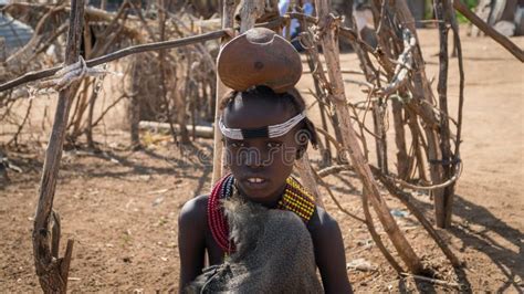 Unidentified Girl From Dassanech Tribe Standing On A Branch Ethiopia