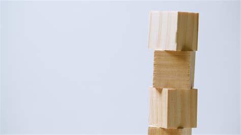 Premium Stock Video Small Wooden Cubes Stacked On A Rotating Surface