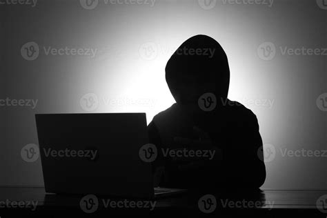 Mysterious Man Wearing Black Hoodie Using Laptop And Holding Credit Card In The Dark Room