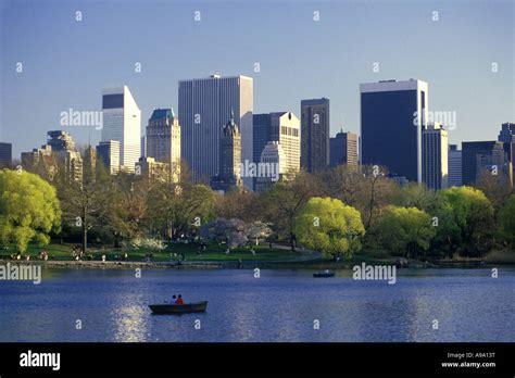 ROW BOATS SPRINGTIME LAKE CENTRAL PARK MIDTOWN MANHATTAN SKYLINE NEW