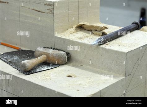 Block Of Sandstone In A Stonemason Workshop With Chisel And Brush Stock