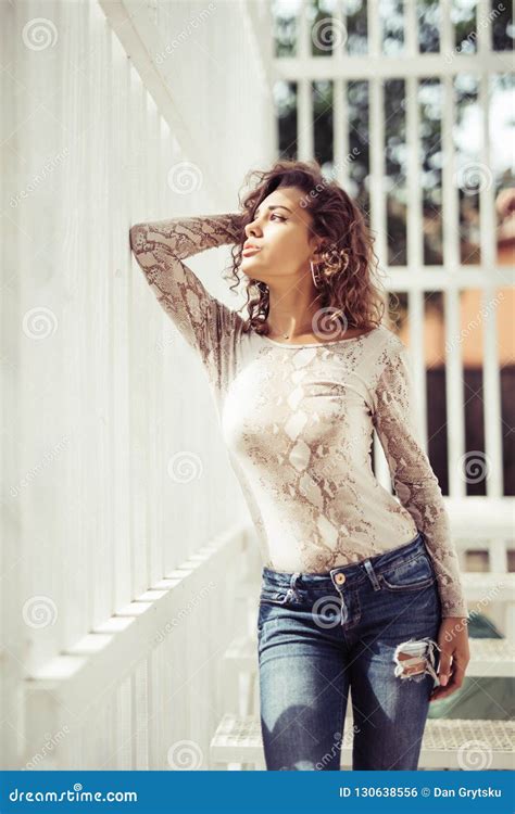 Young Curly Latin Girl Against Wooden Strip Wall Fashion Style Outdoor