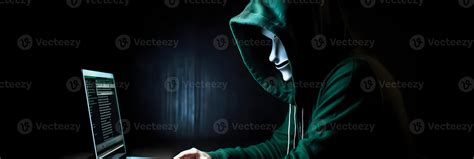 Unveiling The Enigmatic World Of Cybercrime A White Masked Hacker S Front View Amidst Dark Hood