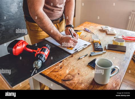 Man Making Draft Plan Using Pencil On The Table With Tools Stock Photo Alamy