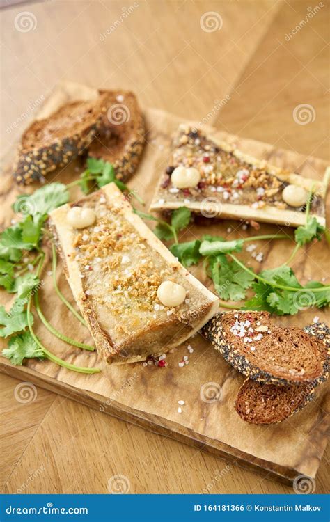 Beef Bone Marrow With Chimichurri Sauce And Toasted Bun Served On A