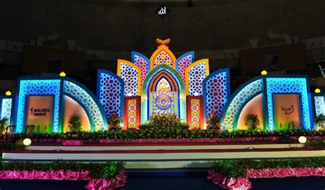 The Stage Is Decorated With Colorful Lights And Greenery For An Event
