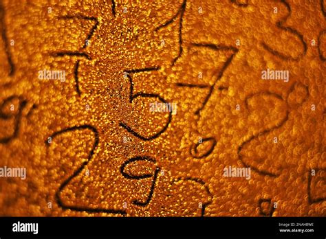 Different Numbers Painted On Shiny Sand A Numerical Background On Gold