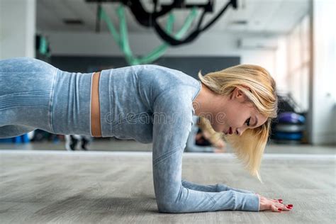 Young Athletic Slim Woman Trainer Fitness Instructor Doing Sports In