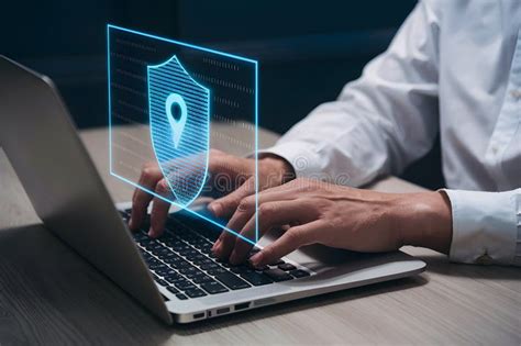 Person Typing With Digital Shield Overlay On Laptop For Data Protection Seated At Desk Stock
