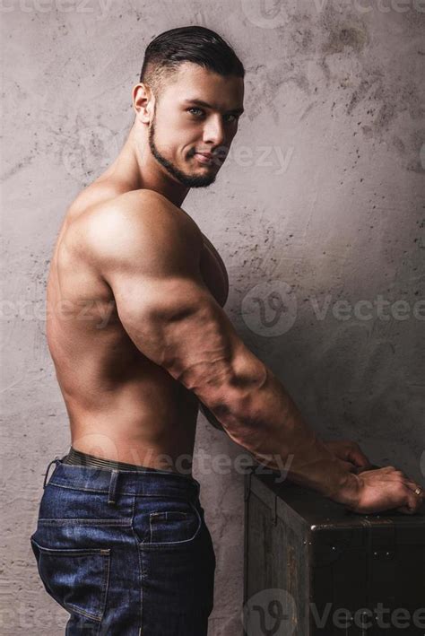 Massive Bodybuilder Posing Beside The Concrete Wall 16237629 Stock