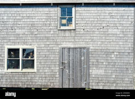 The Exterior Of A Worn Grey Weathered Wooden Wall Of A Shed Or Barn