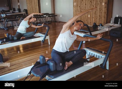 Women Practicing Pilates On Reformer In Fitness Studio Stock Photo Alamy