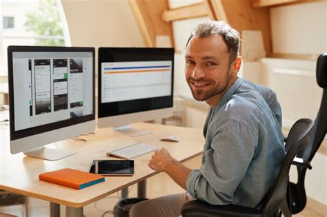 Premium Photo Portrait Of Programmer Smiling At Camera While Sitting