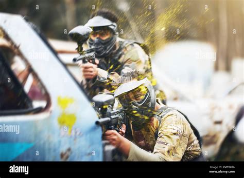 Paintball Shooting And People In Action Competition Game Or Match As