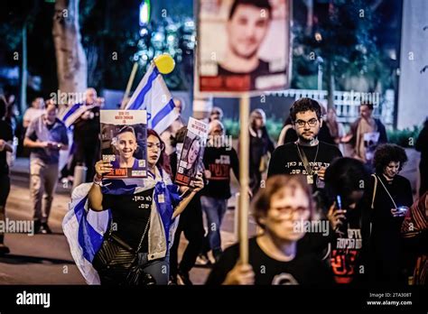 Israelis March Through The Streets While Holding Photos Of Held