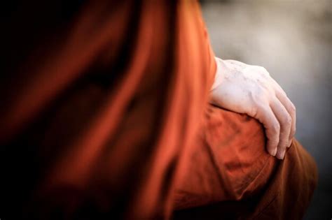 Premium Photo Midsection Of Monk Sitting On Seat